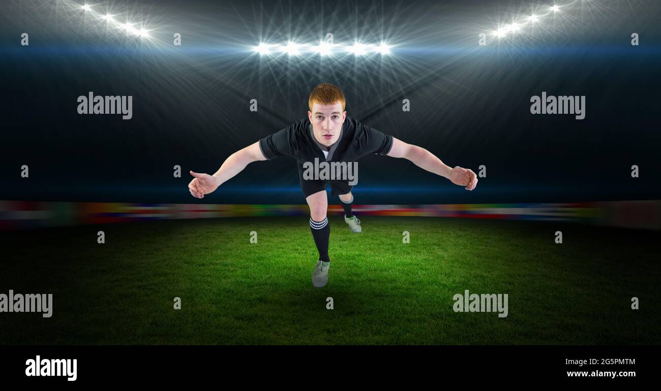 Composition of male rugby player jumping at rugby stadium Stock Photo ...