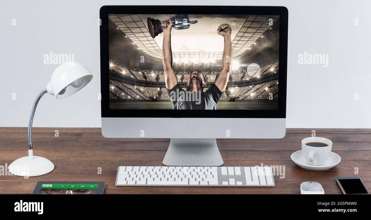 Composition of male rugby player holding cup at rugby stadium on ...