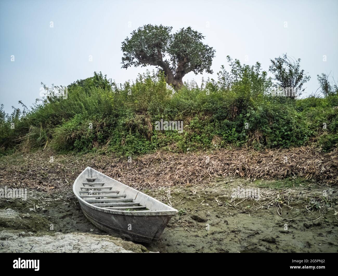 Wooden boat on a gloomy lakeshore Stock Photo - Alamy