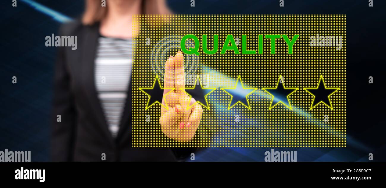 Woman touching a quality concept on a touch screen with her fingers ...
