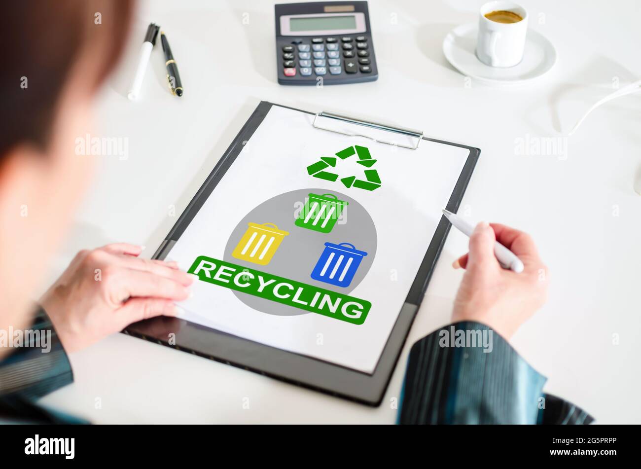Woman looking at a recycling concept Stock Photo - Alamy