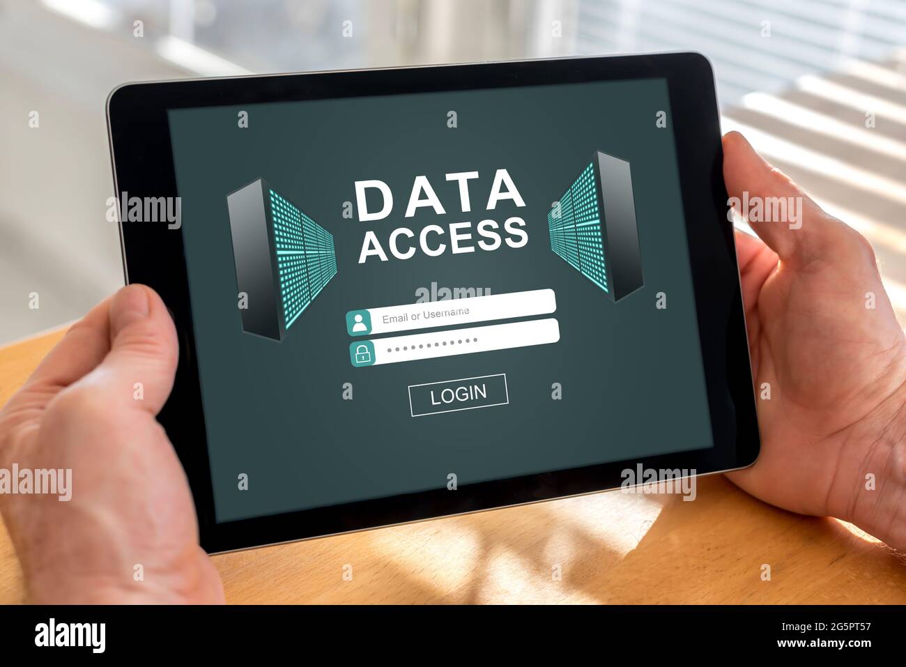 Male hands holding a tablet with data access concept Stock Photo - Alamy