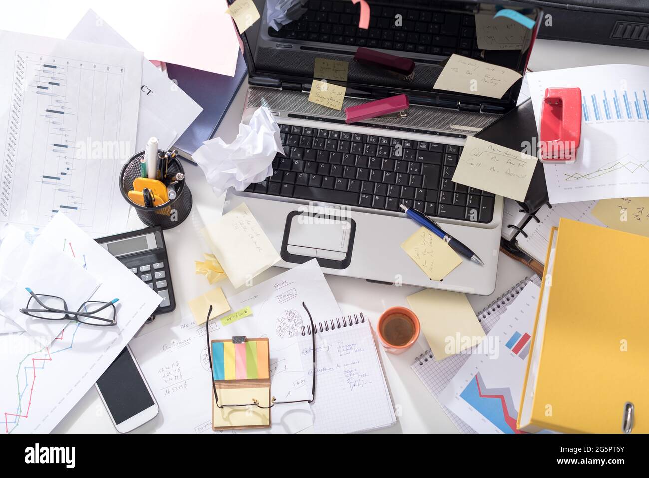 Messy and cluttered office desk Stock Photo - Alamy