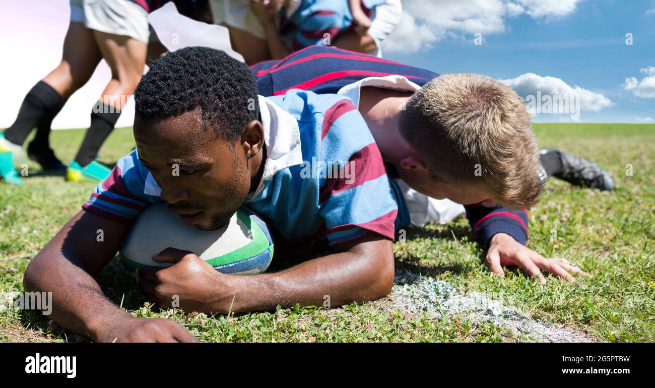 Composition of male rugby team playing and holding rugby ball at ...