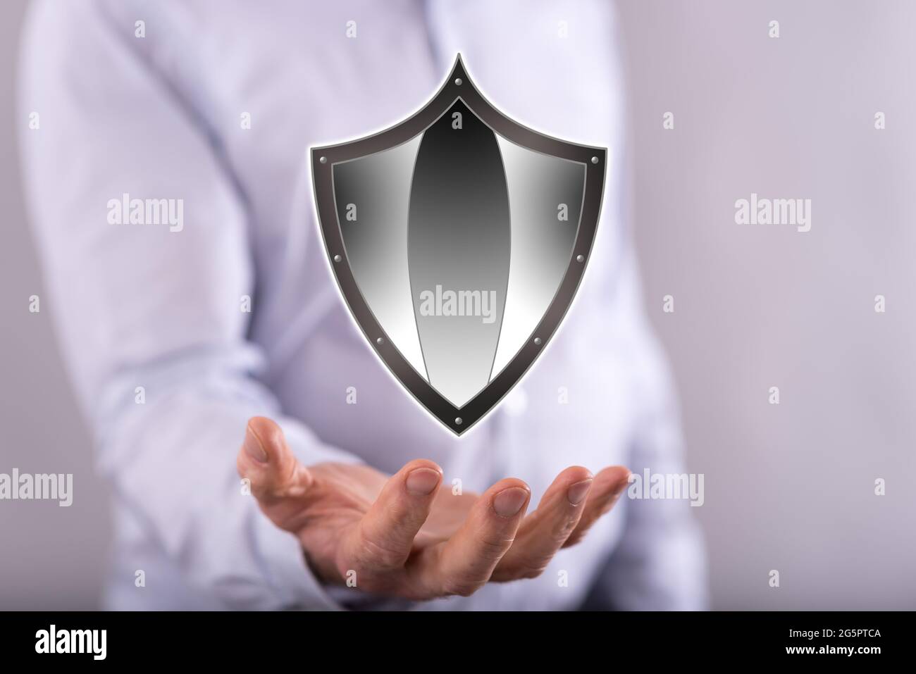 Protection concept above the hand of a man in background Stock Photo ...