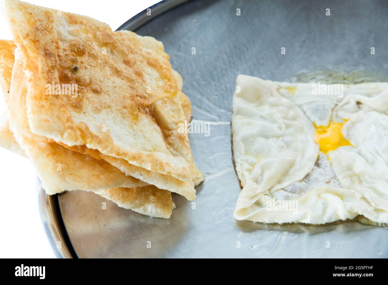 Hot crispy Roti with eggs, sweet dessert fried on hot pan Stock Photo ...