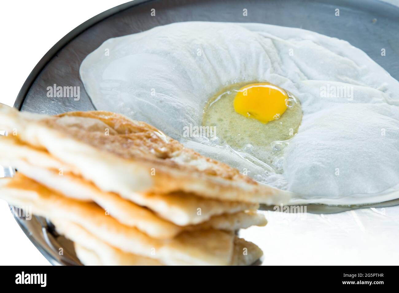 Hot crispy Roti with eggs, sweet dessert fried on hot pan Stock Photo ...