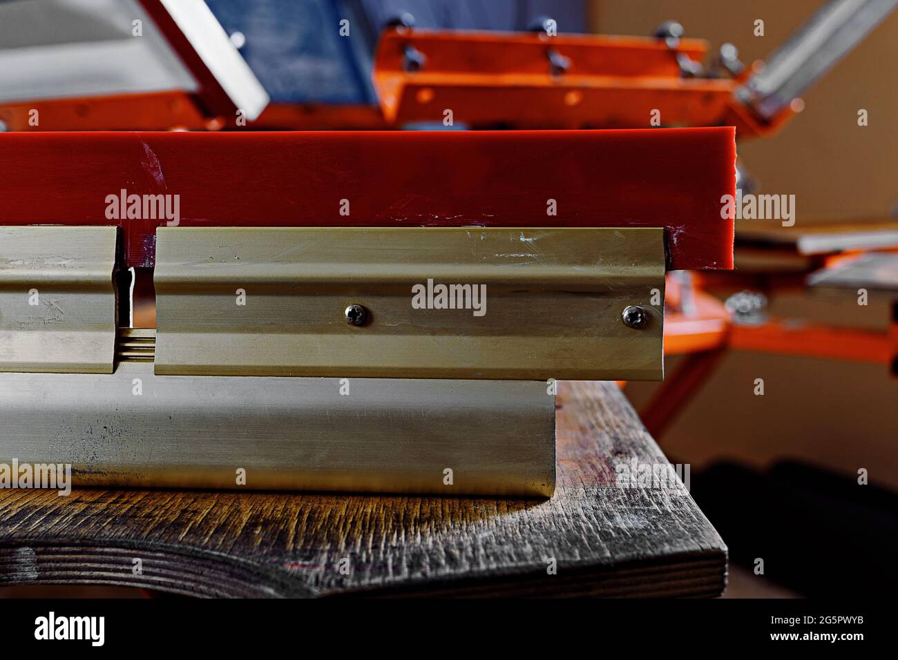 selective focus photo of a squeegee on wooden shelve of the print ...