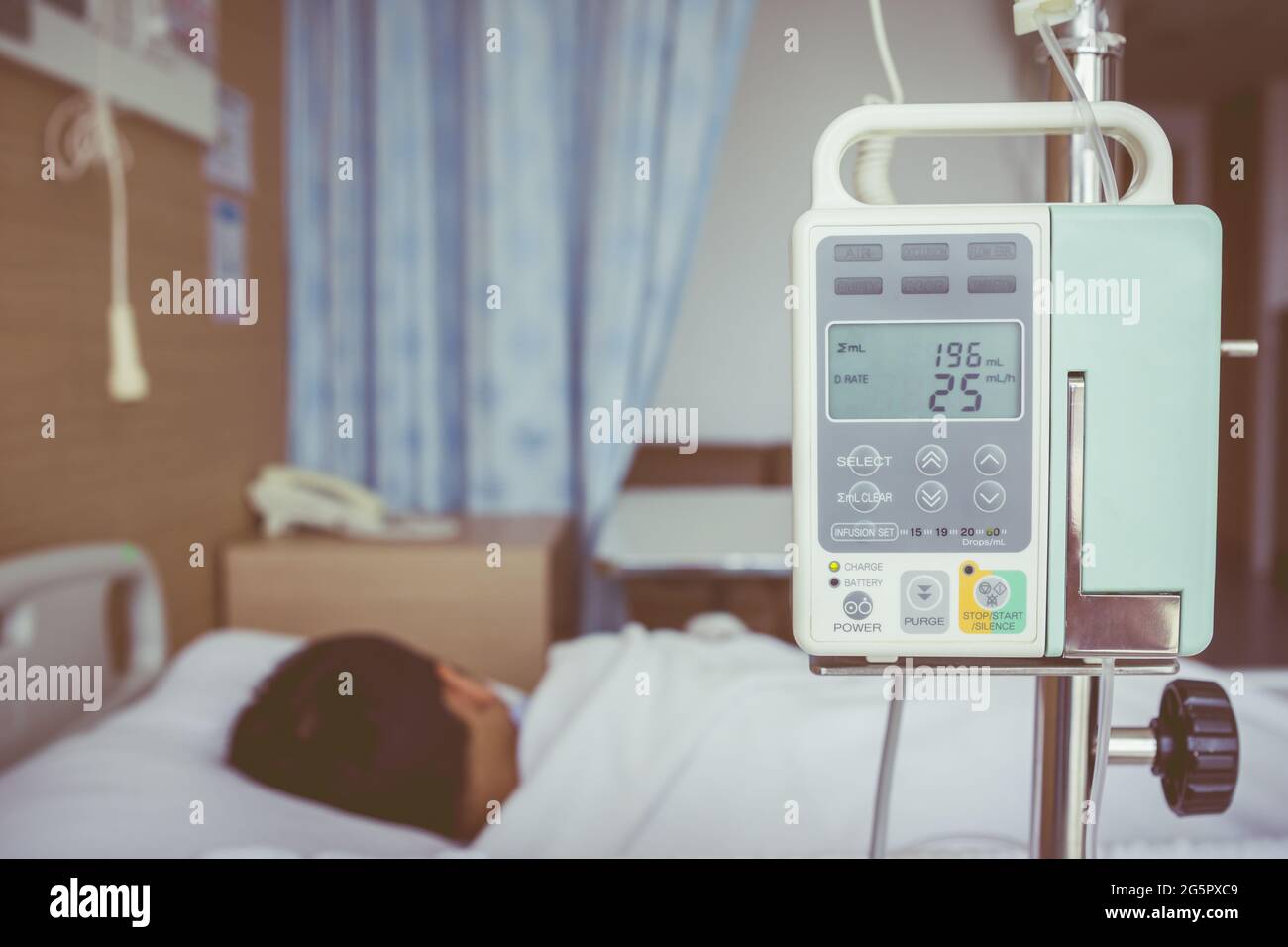 Illness asian boy lying on sickbed in hospital with infusion pump ...