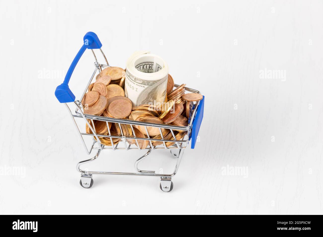 metal chrome shiny shopping trolley on wheels with gold coins and paper ...
