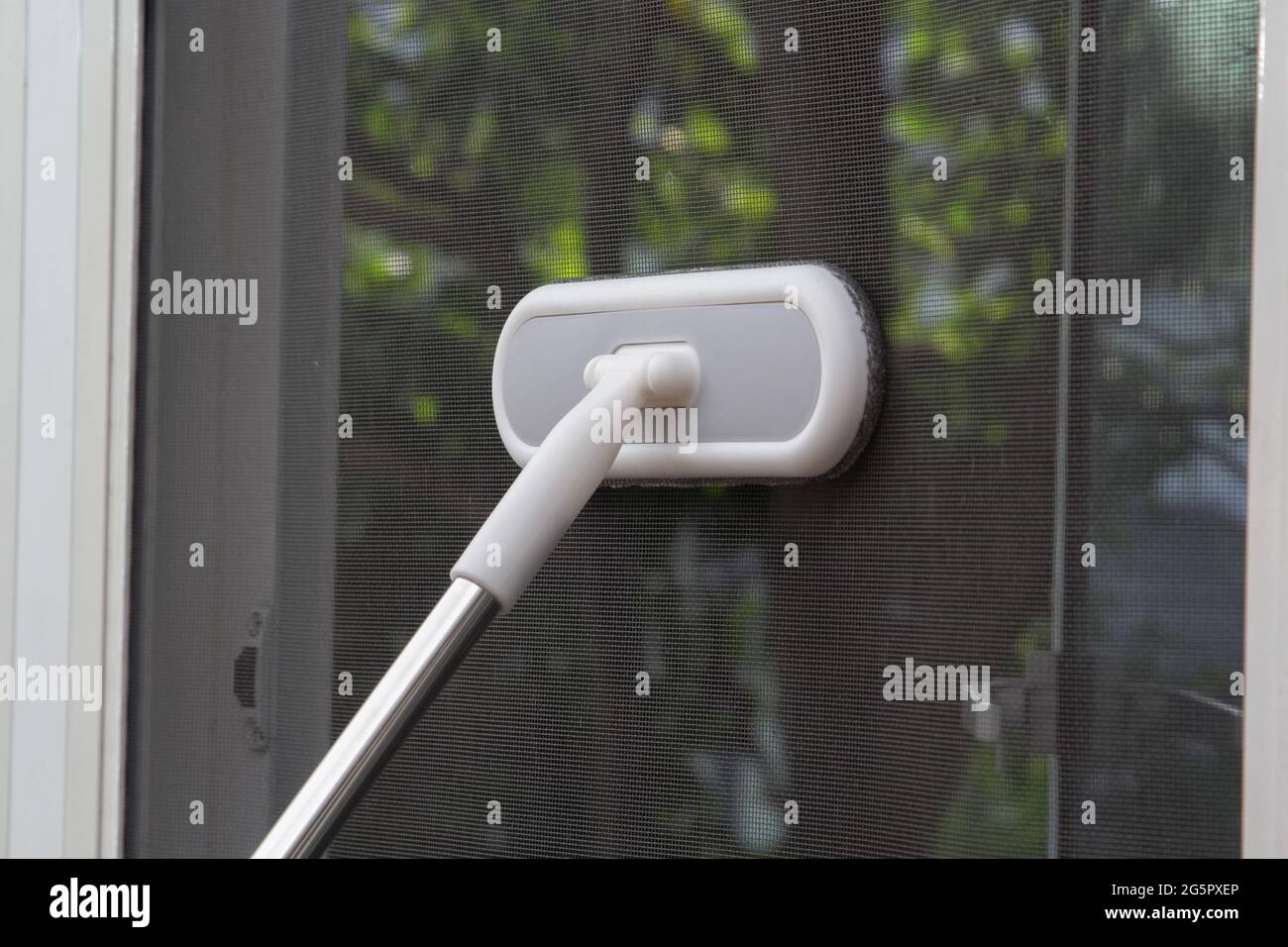 Cleaning dirty mosquito net window with a special window cleaning mop ...