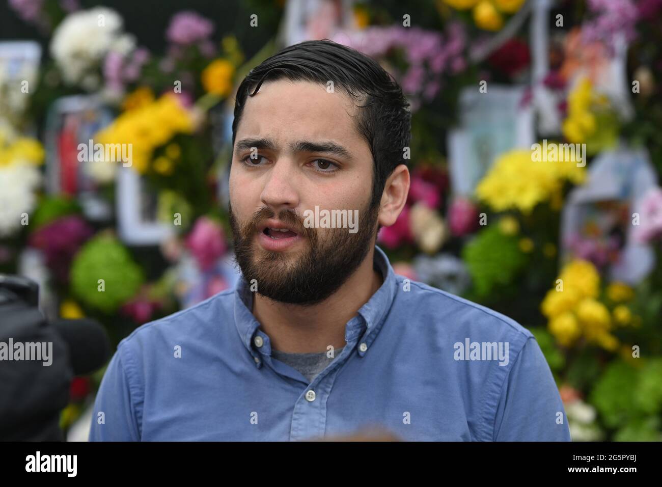 Surfside FL, USA. 28th June, 2021. Leo Soto the coordinator of the make shift memorial is seen ...
