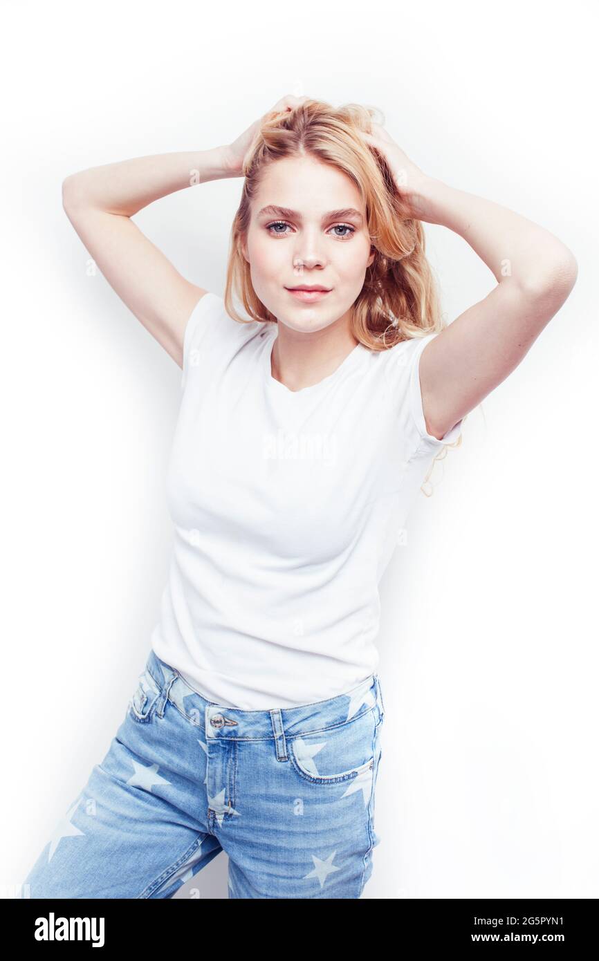 young pretty stylish blond hipster girl posing emotional isolated on ...