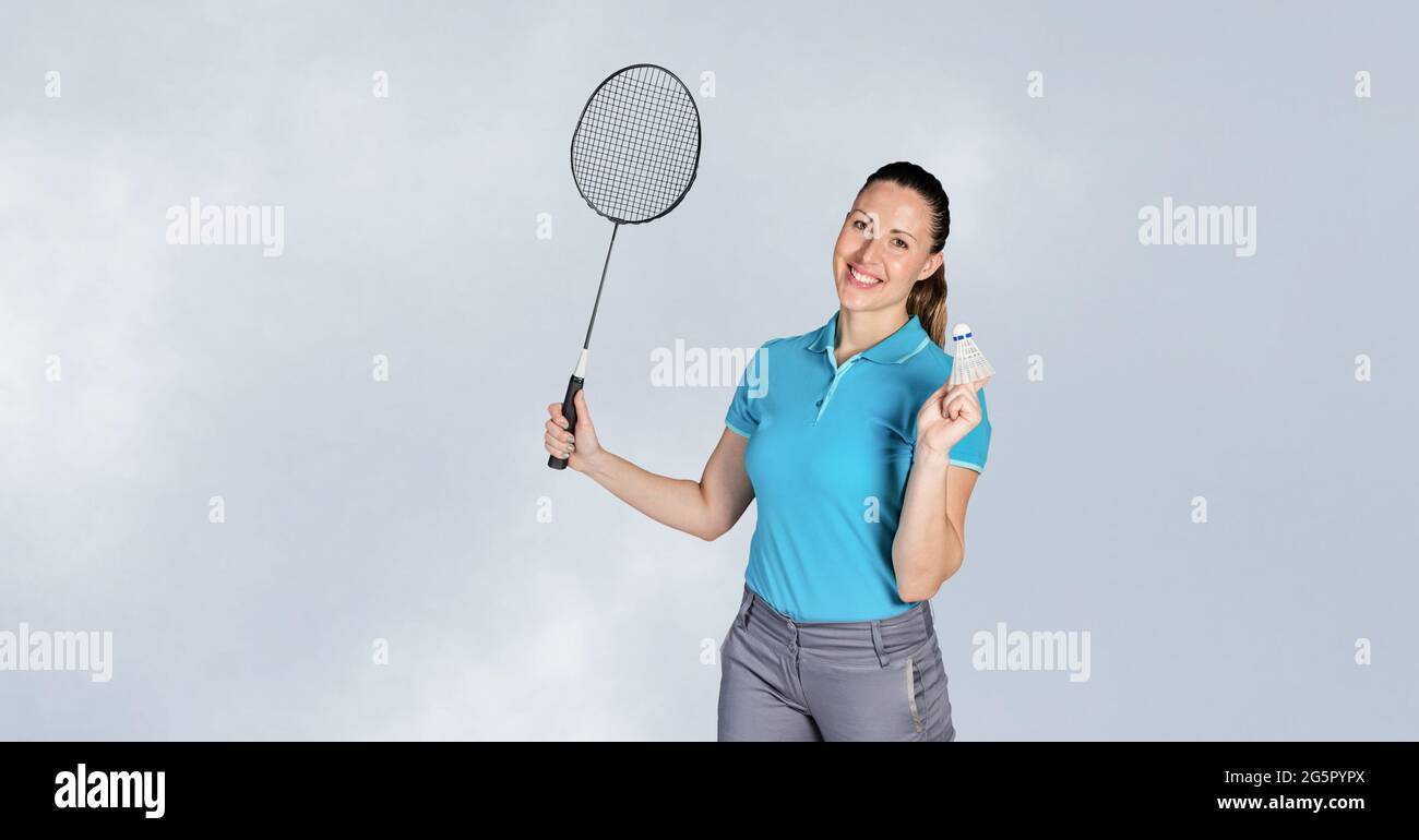 Portrait of caucasian female badminton player holding racket smiling ...