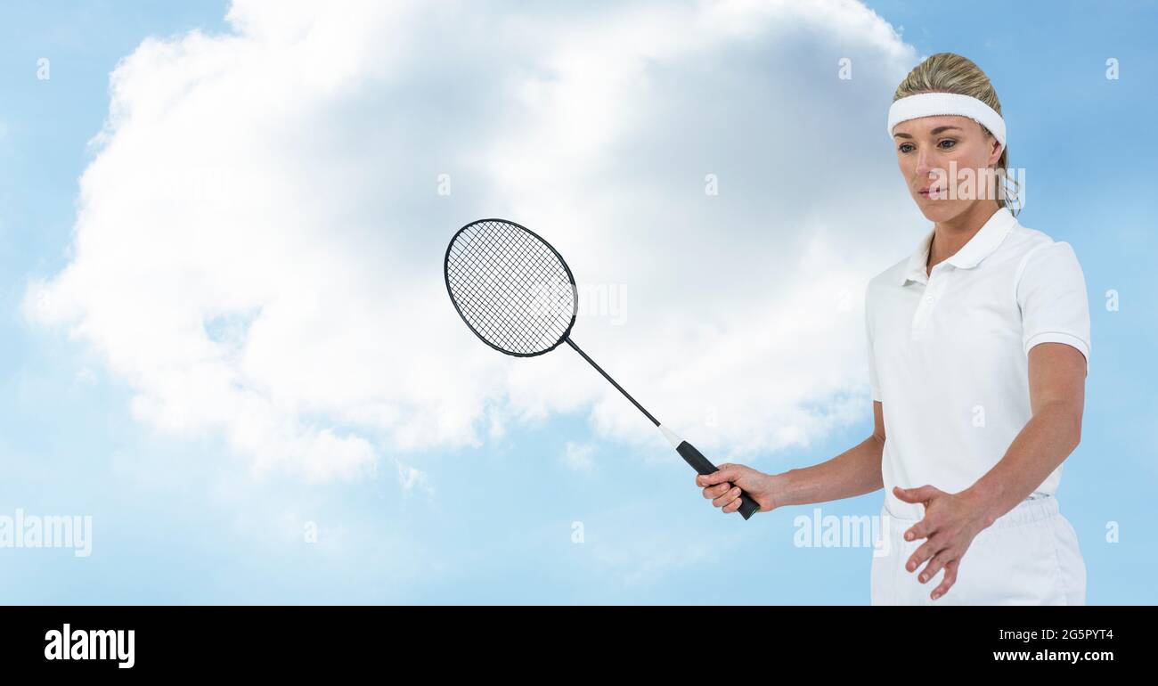Caucasian female badminton player holding racket against clouds in blue ...