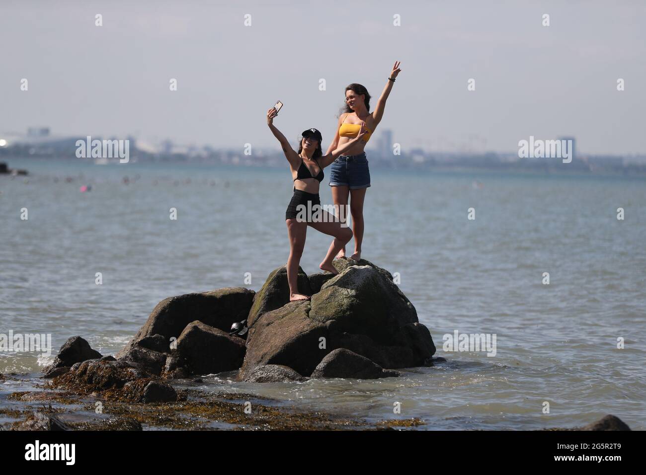 Ana Laura Santos (left) and Camilla Arribada enjoy the good weather at ...