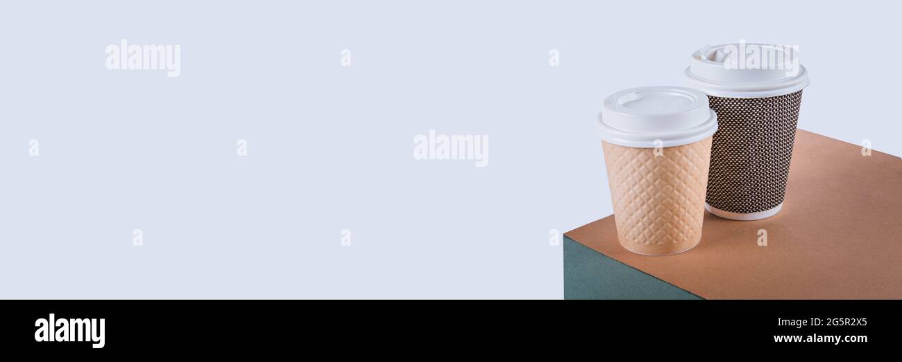 Two craft paper disposable coffee cups. Banner with a white background ...