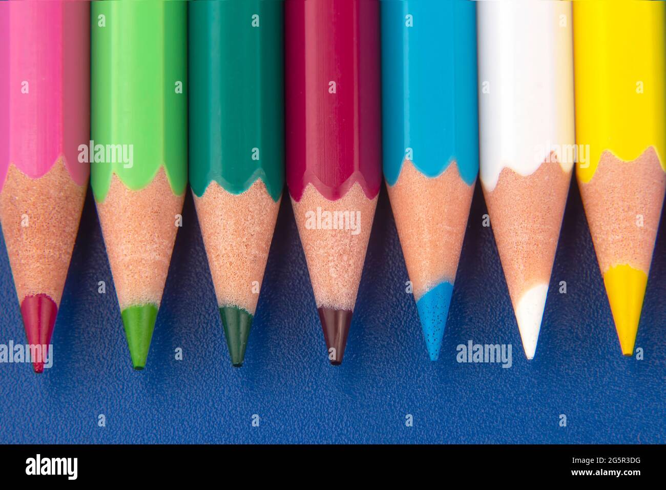 set of color pencils on a bright blue background. drawing tools. a ...