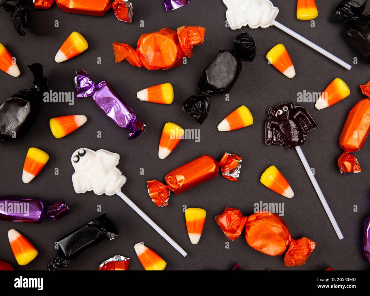Halloween Candy Background on a Black Surface Stock Photo - Alamy