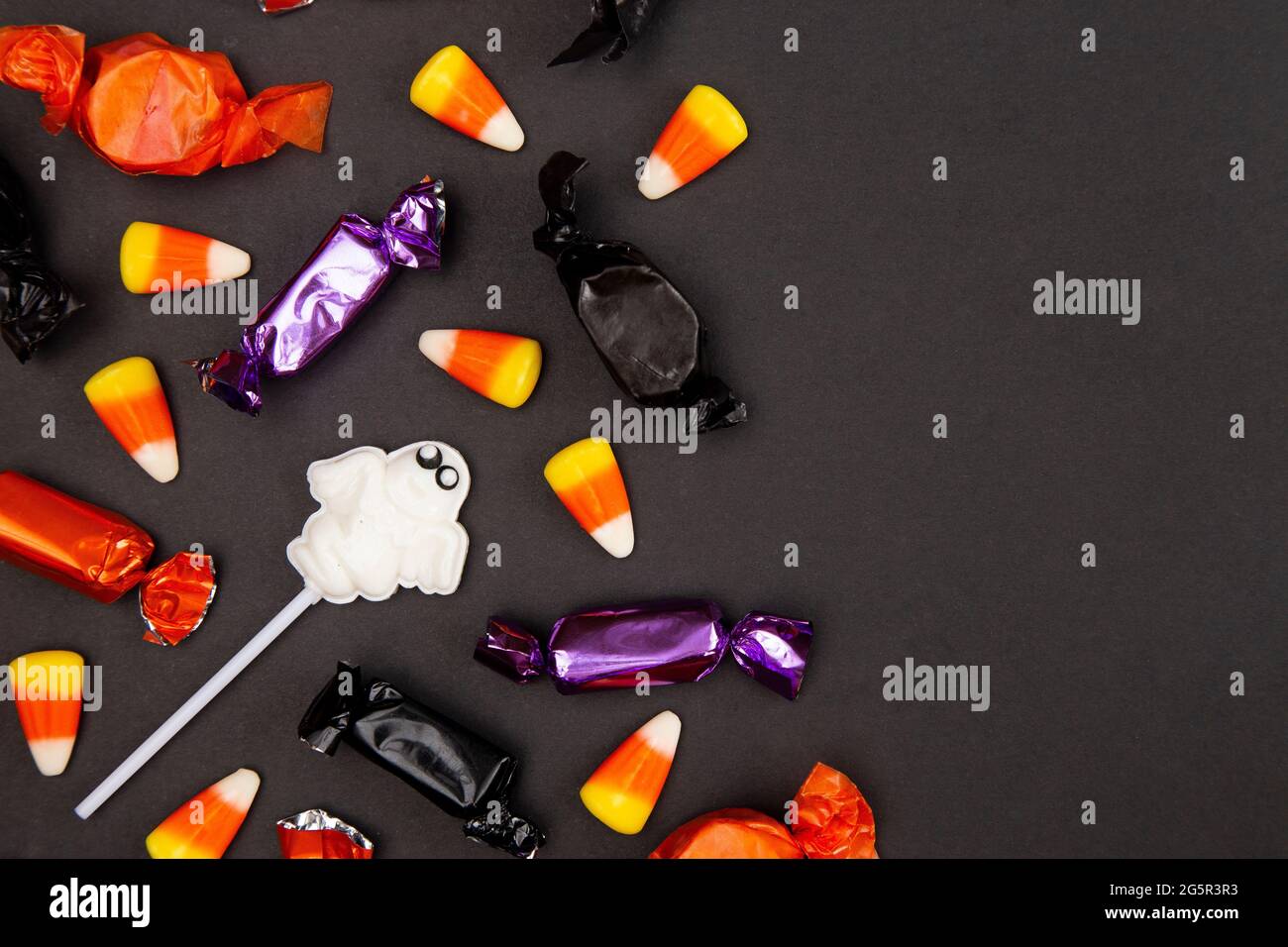 Halloween Candy Background on a Black Surface Stock Photo - Alamy
