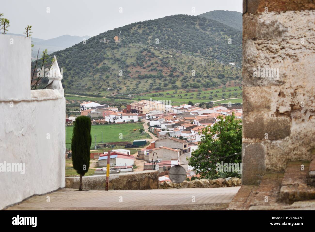 Rural street in a village of southern Spain with old walls and houses ...