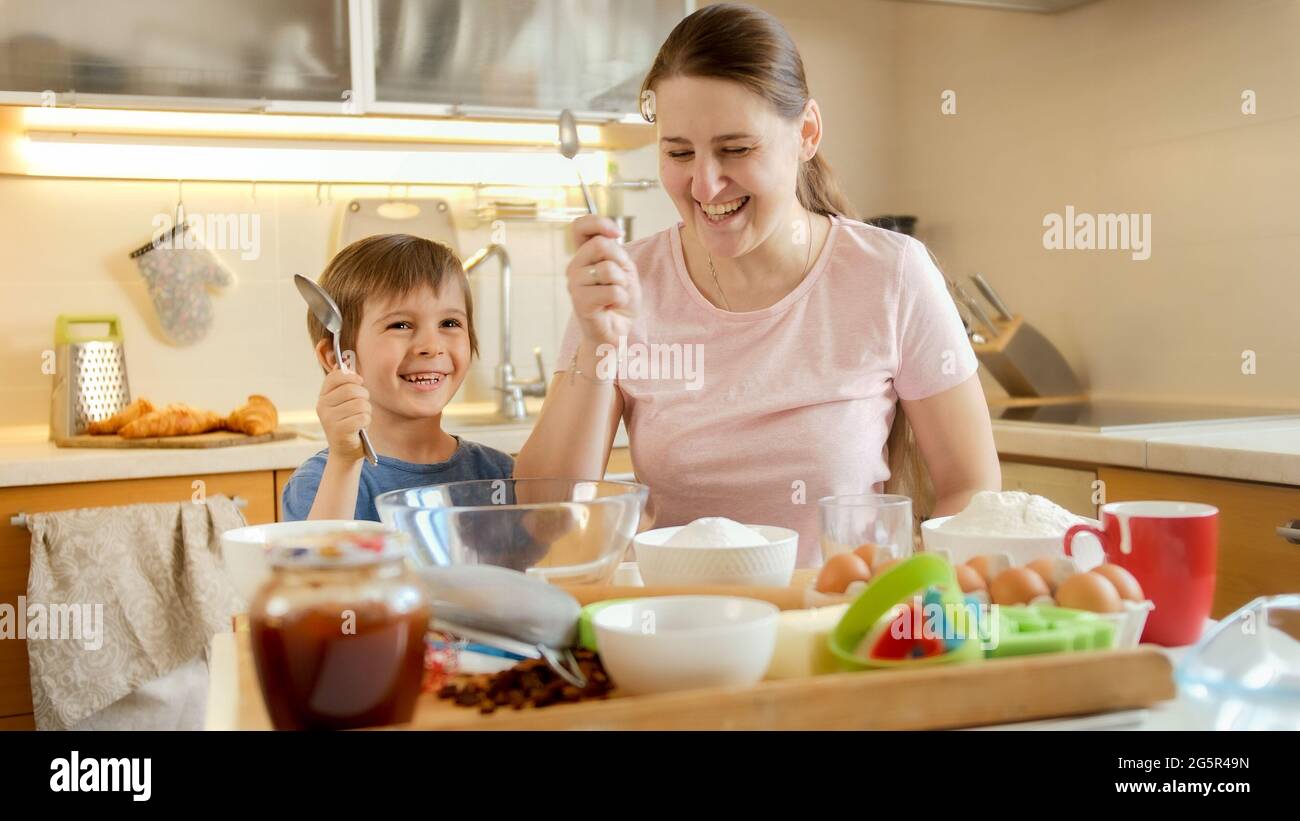 Little boy with mother looking on ingredients for cooking tasty dish ...
