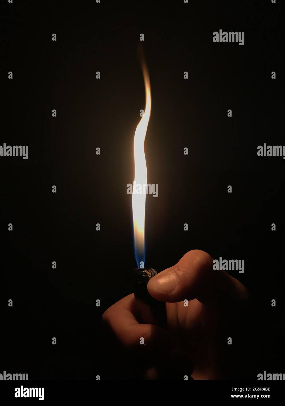 Photo of a dark room while holding a lit lighter with a high flame ...