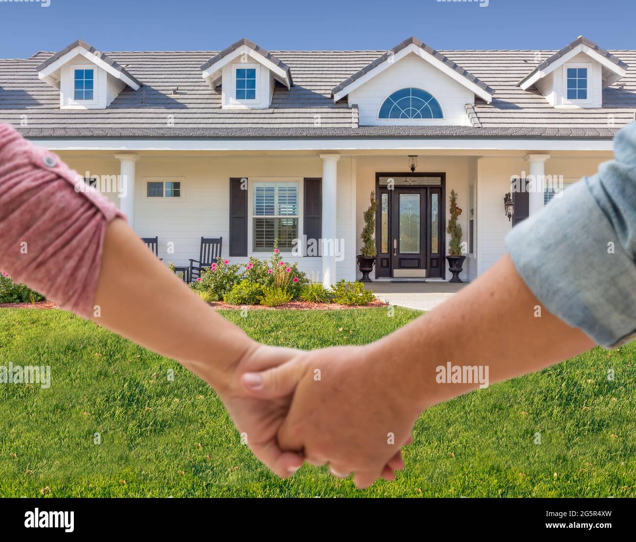 Couple Holding Hands Approaching Front Door Of New House Stock Photo ...