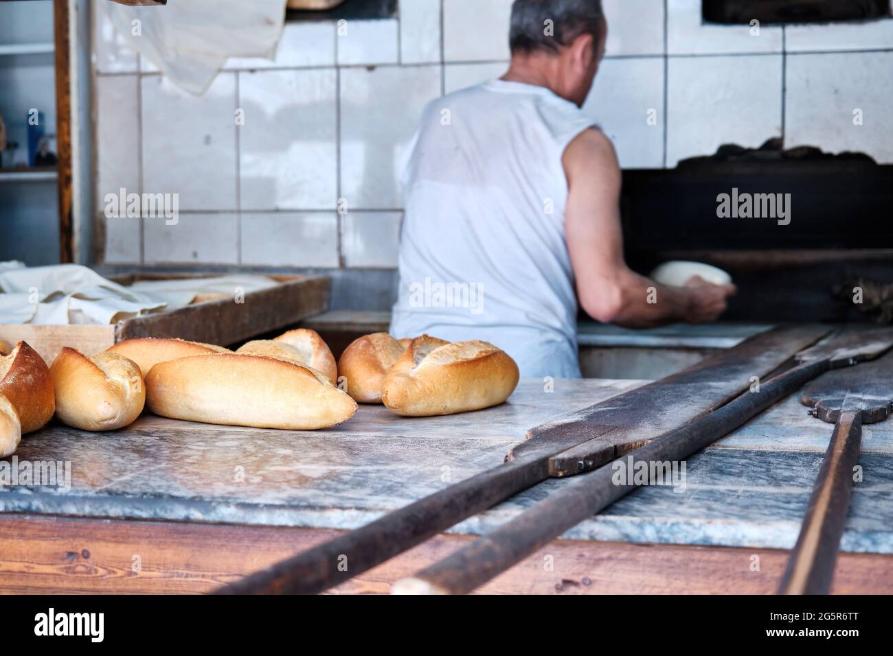 Baker cooking bread at a traditional authentic bakehouse Stock Photo ...