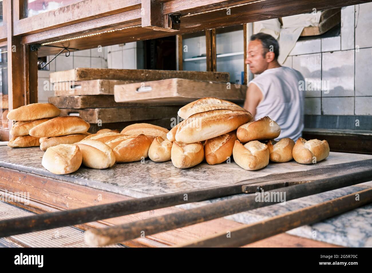 Baker cooking bread at a traditional authentic bakehouse Stock Photo ...