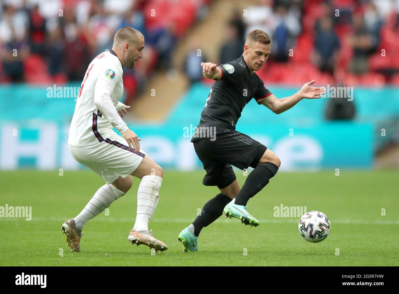 England's Luke Shaw (left) and Germany's Joshua Kimmich battle for the ...