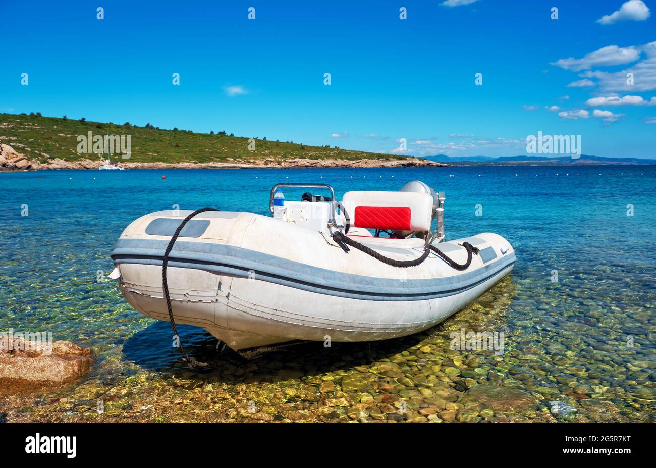 Inflatable rubber motorboat at the shore with beautiful holiday ...