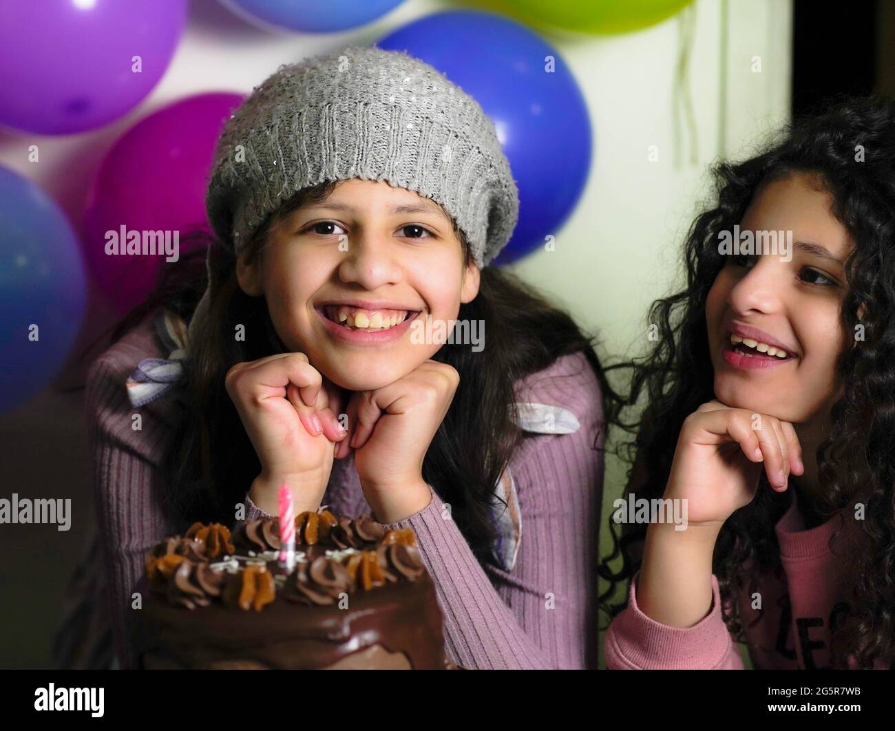 cute girls celebrated their birthday with a chocolate cake accompanied ...