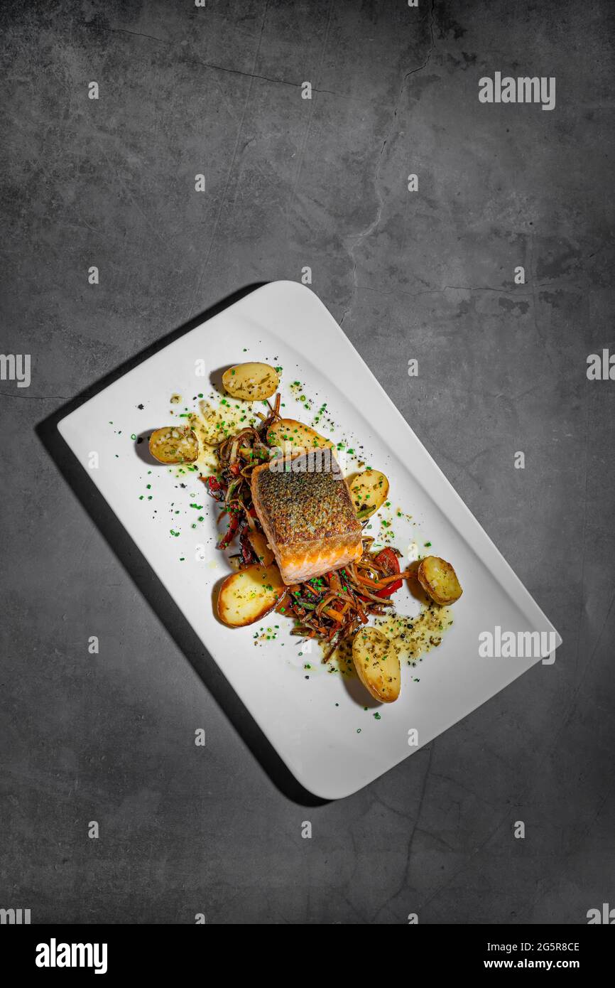Flat lay food photography of grilled salmon steak with potatoes and ...