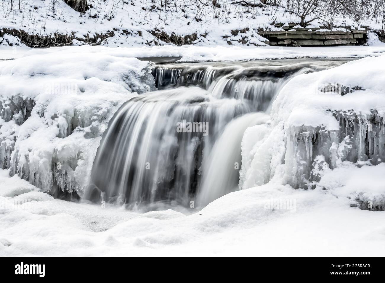 Wintery Waterfall with Ice and Snow Stock Photo - Alamy