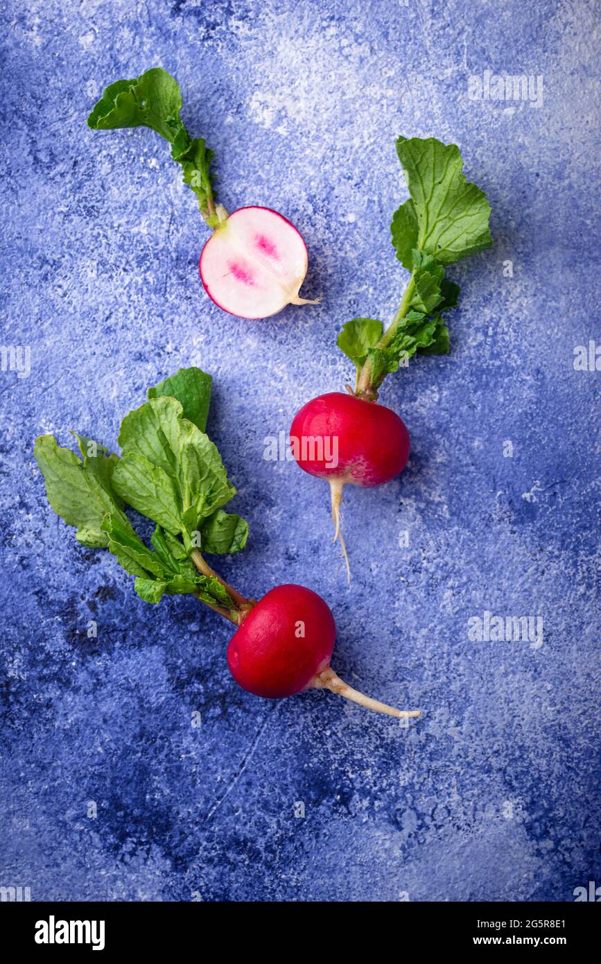 Radish on blue concrete backgrounds Stock Photo - Alamy