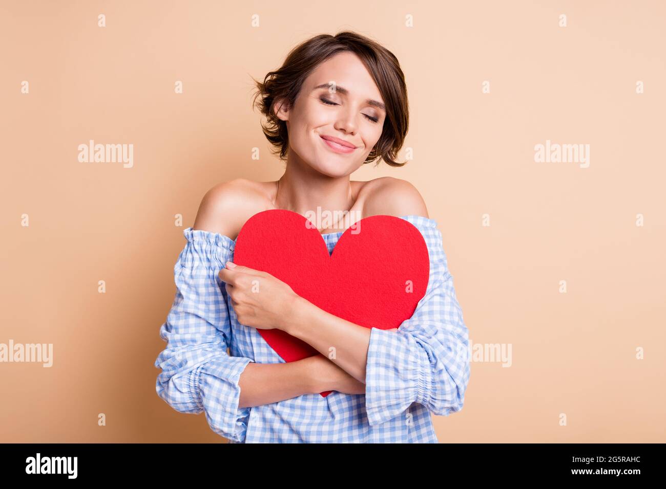 Photo portrait of relaxed woman hugging big red heart card with two ...