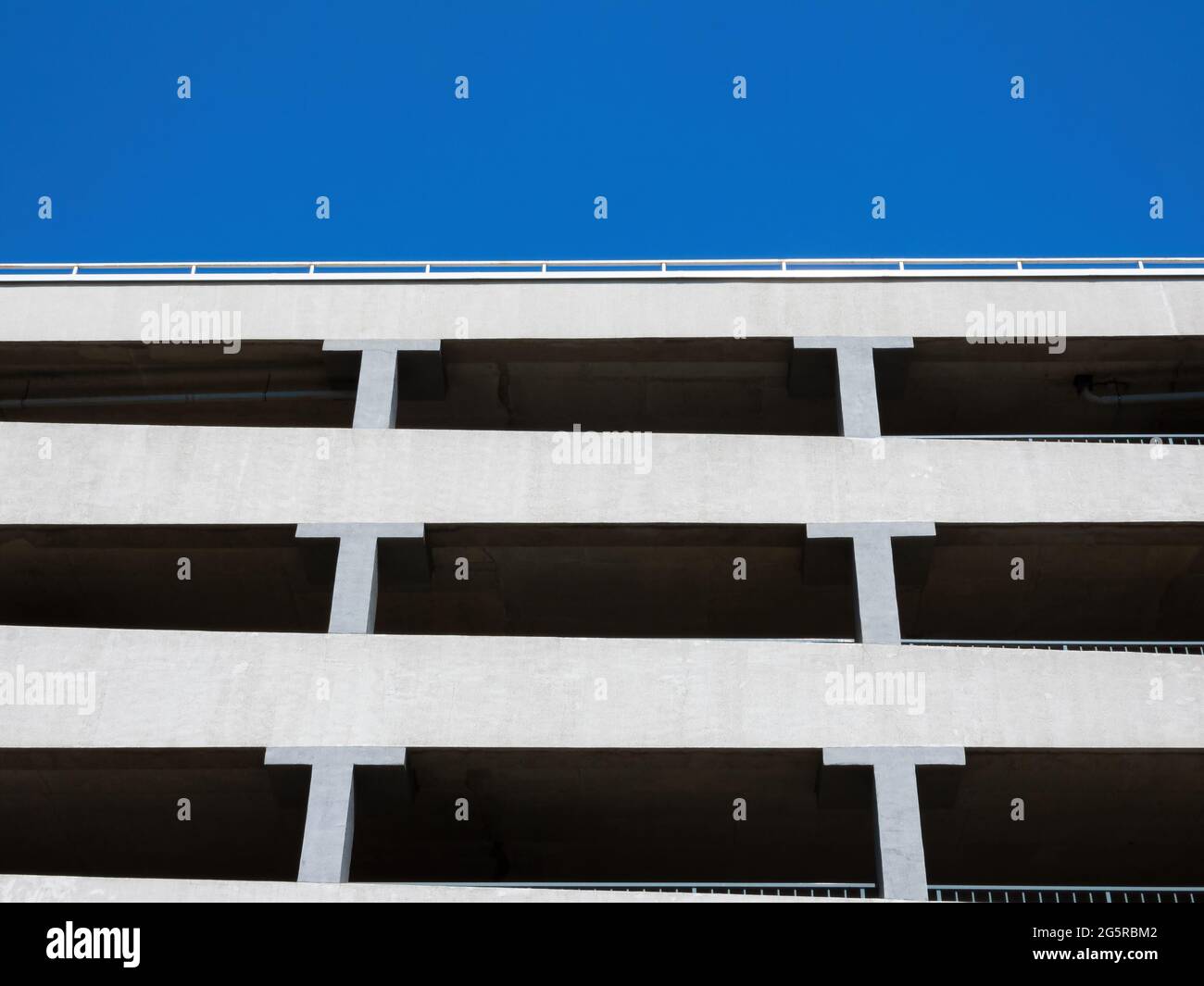 Facade of a multi-level car parking on a background of blue sky Stock ...
