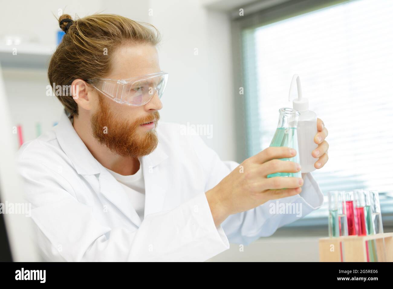 scientist chemist looking at chemicals Stock Photo - Alamy