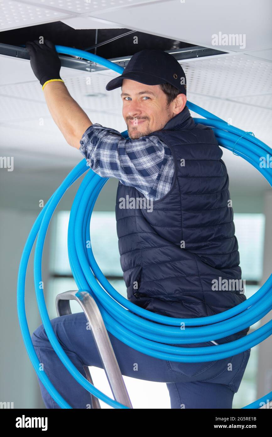 electrical worker wiring in ceiling Stock Photo - Alamy