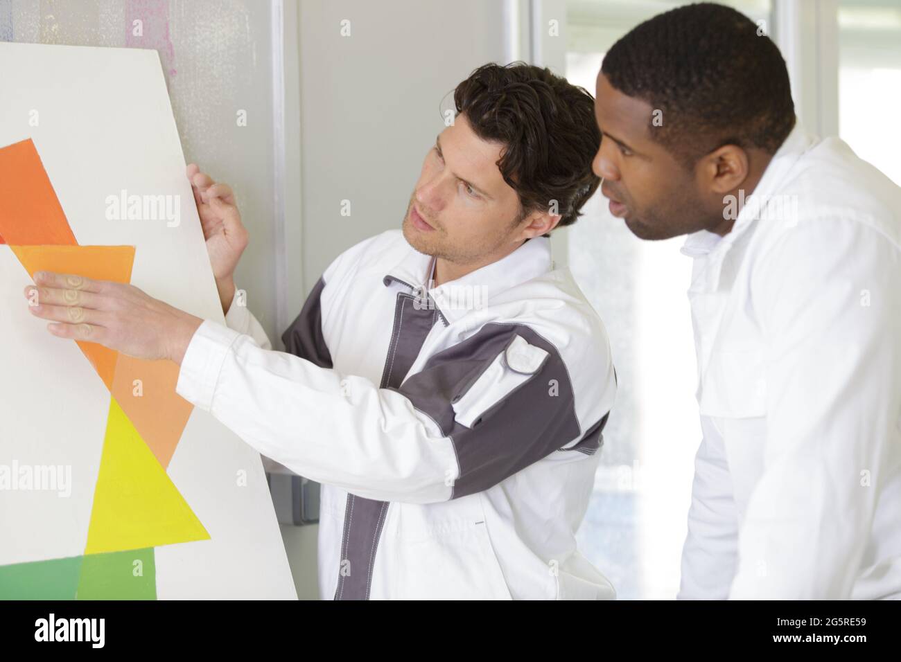 art-teacher discussing basics of painting to student at art-class Stock ...