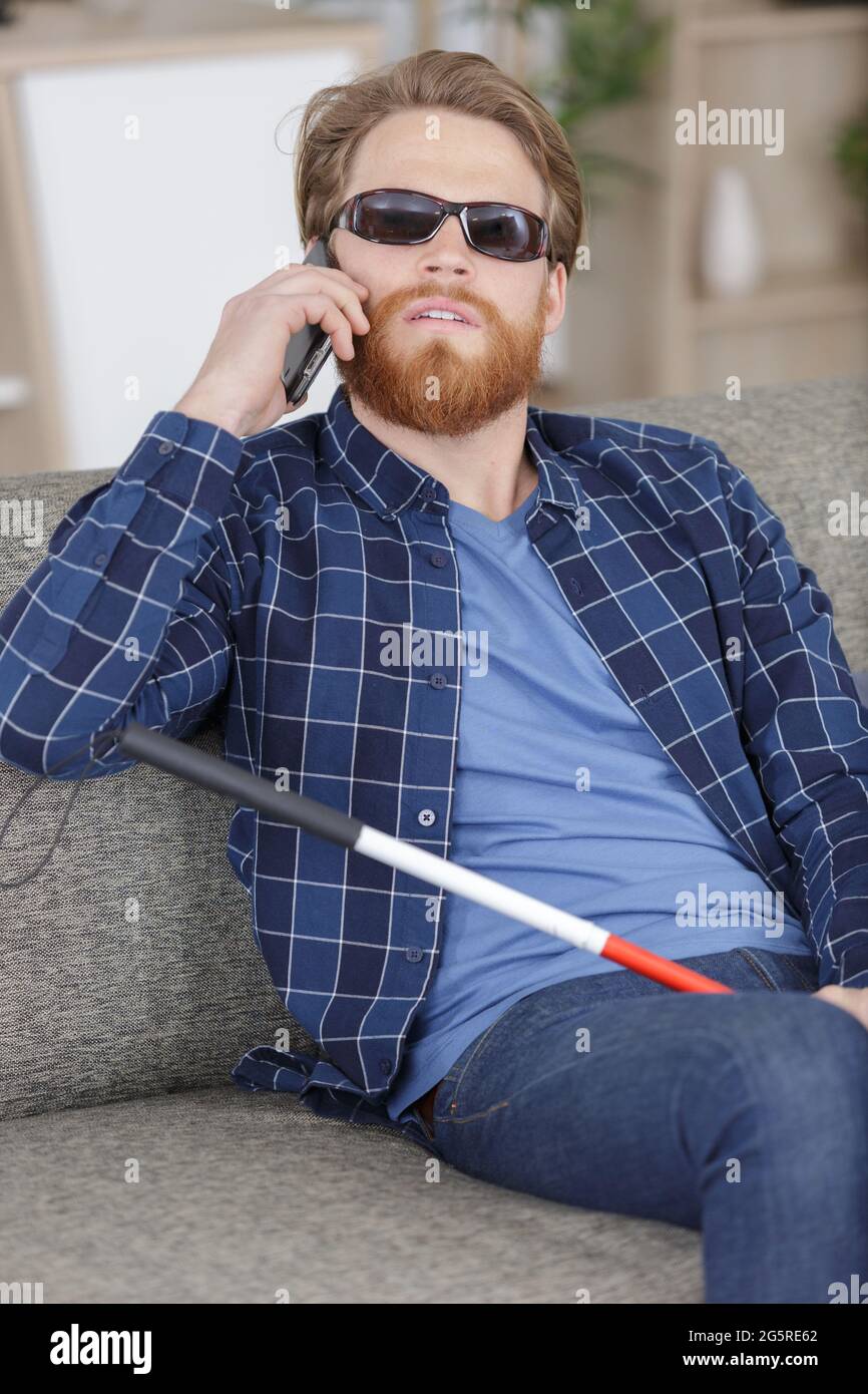 visually impaired man at home making telephone call Stock Photo - Alamy