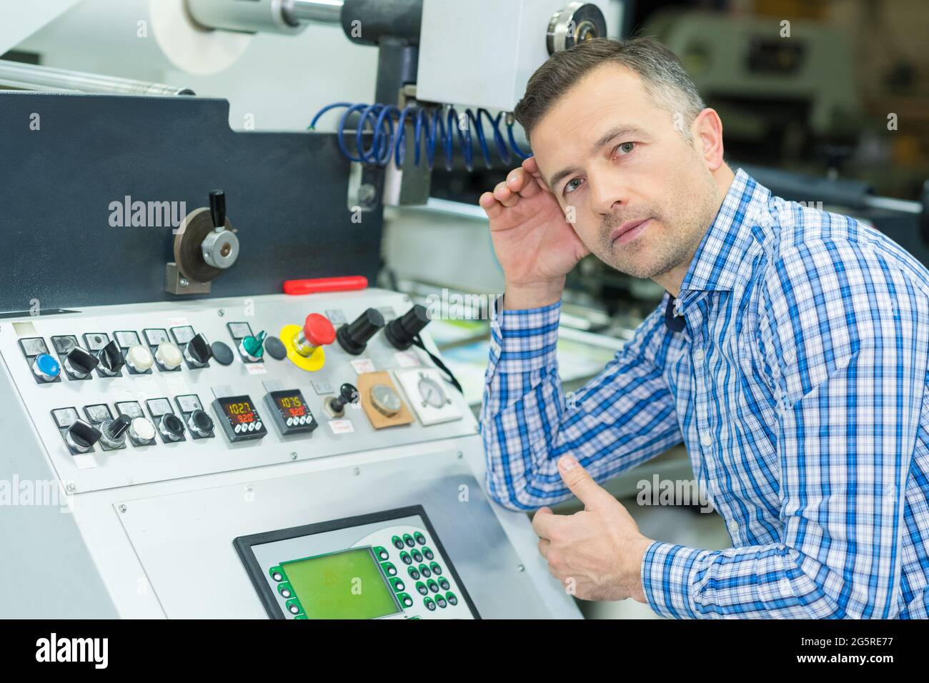asian machine operator in production plant checking data Stock Photo ...