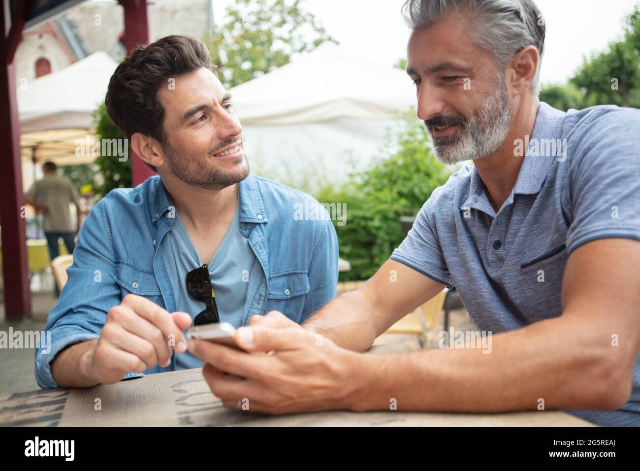meeting of two male friends in bar Stock Photo - Alamy