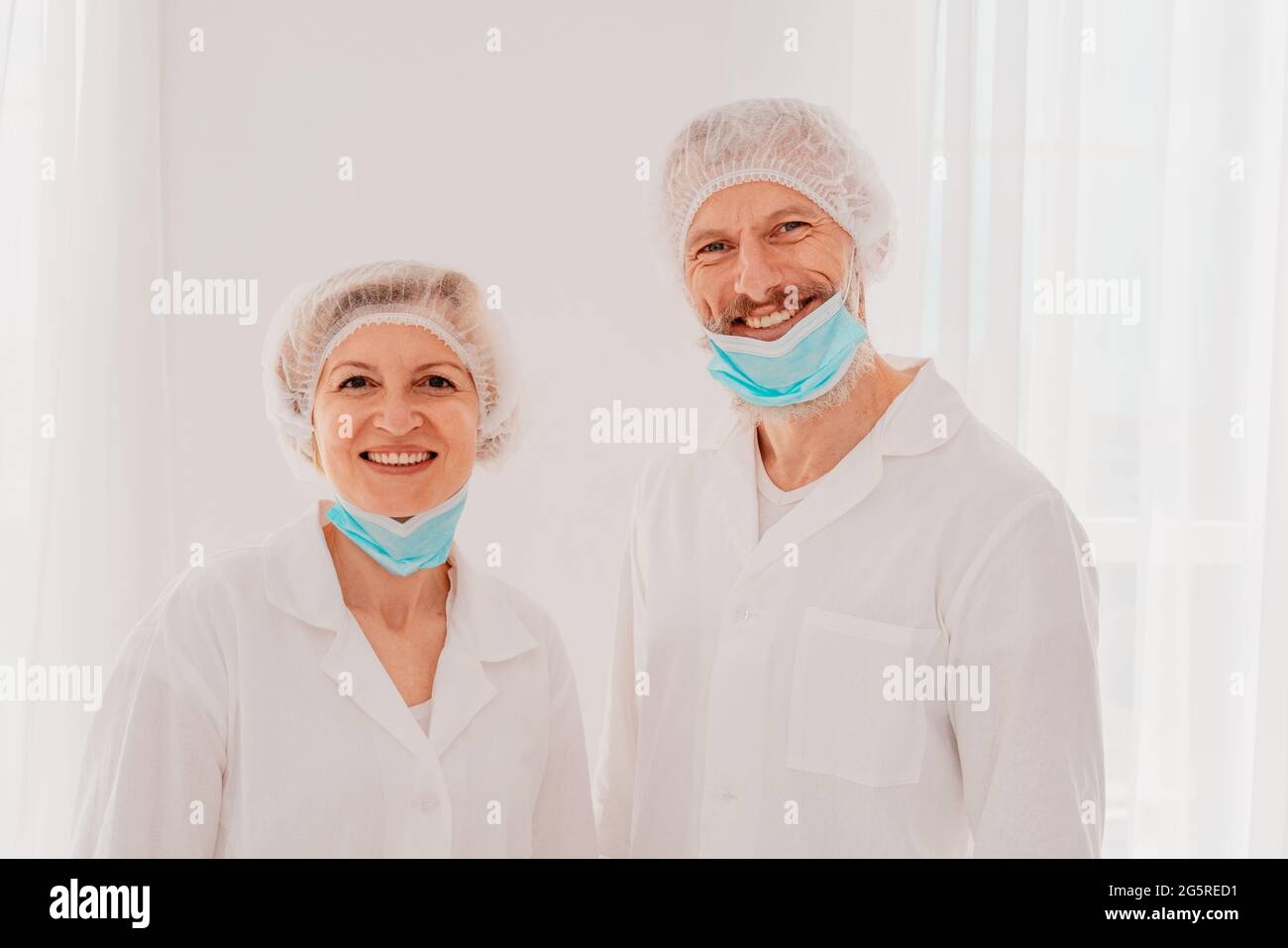 Smiling doctors with face mask are happy to work against covid-19 Stock ...