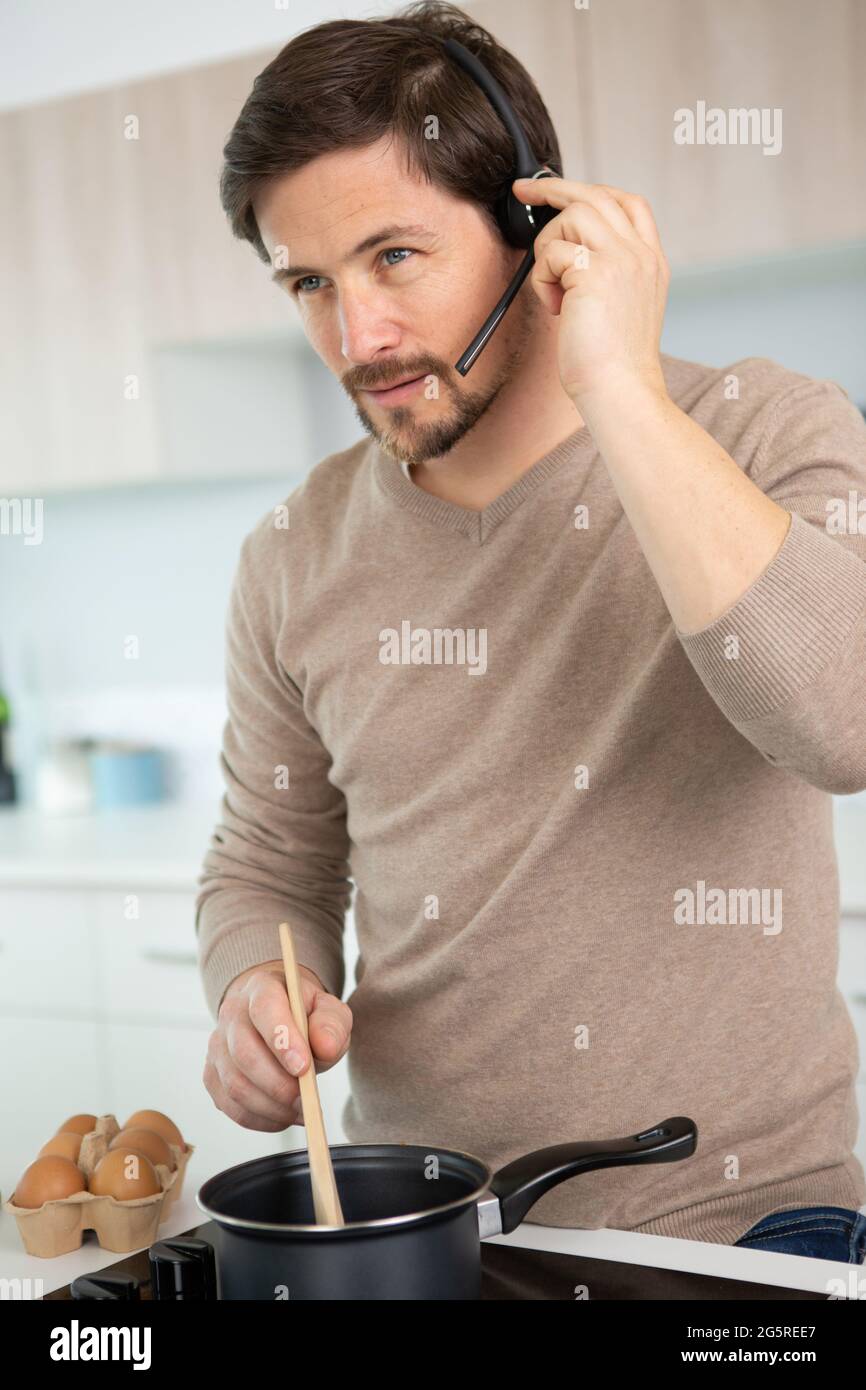 young man on the phone while cooking Stock Photo - Alamy