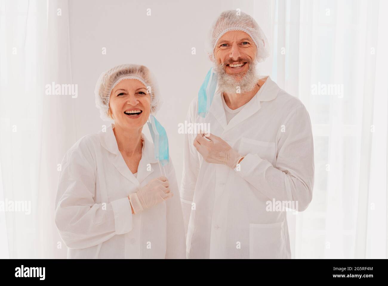 Smiling doctors with face mask are happy to work against covid-19 Stock ...
