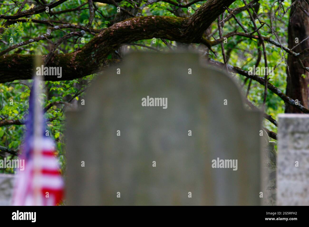 Old Gravestone in the Foreground that is Blurred Out Stock Photo - Alamy