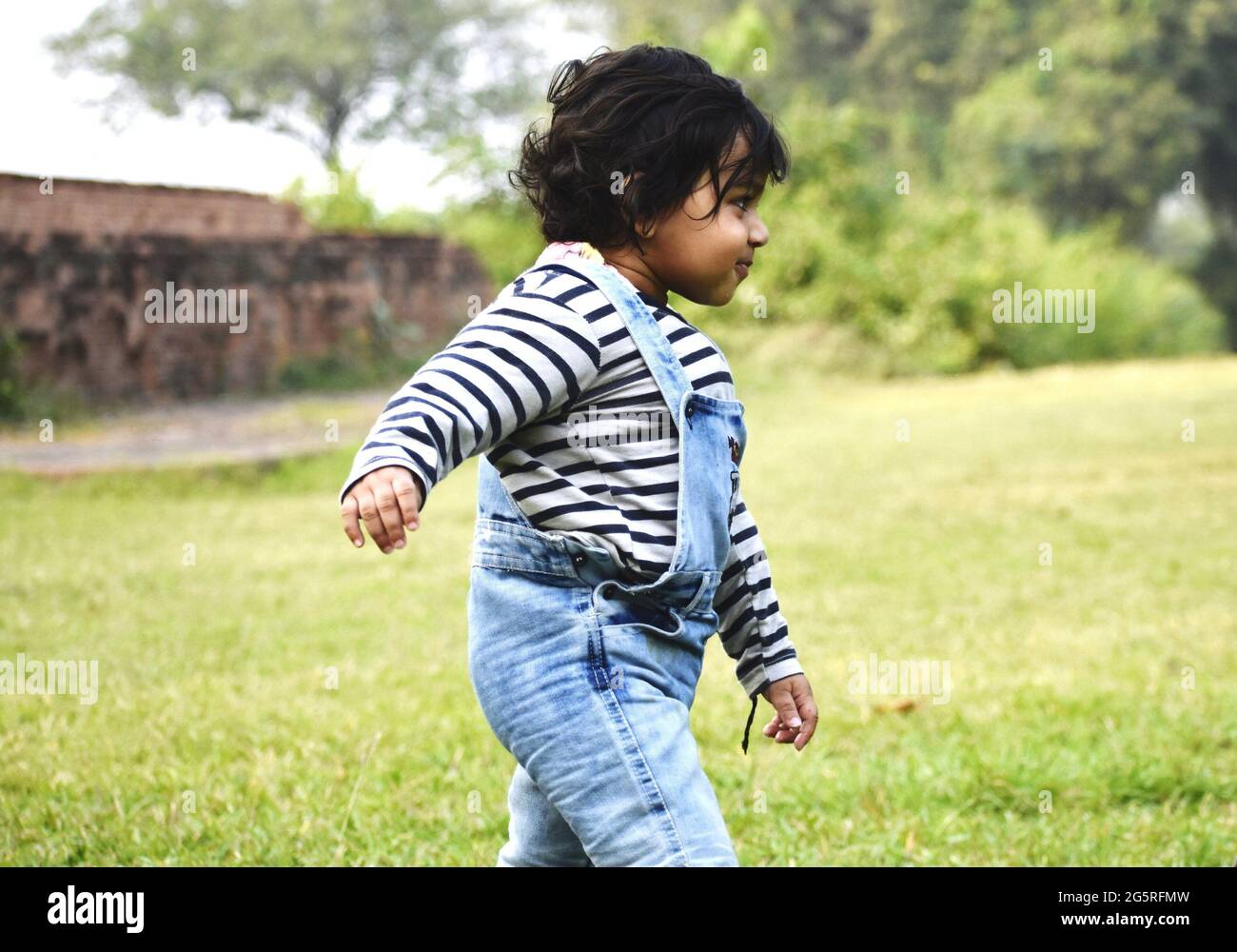 Shallow focus shot of a cute South Asian female toddler outdoors Stock ...