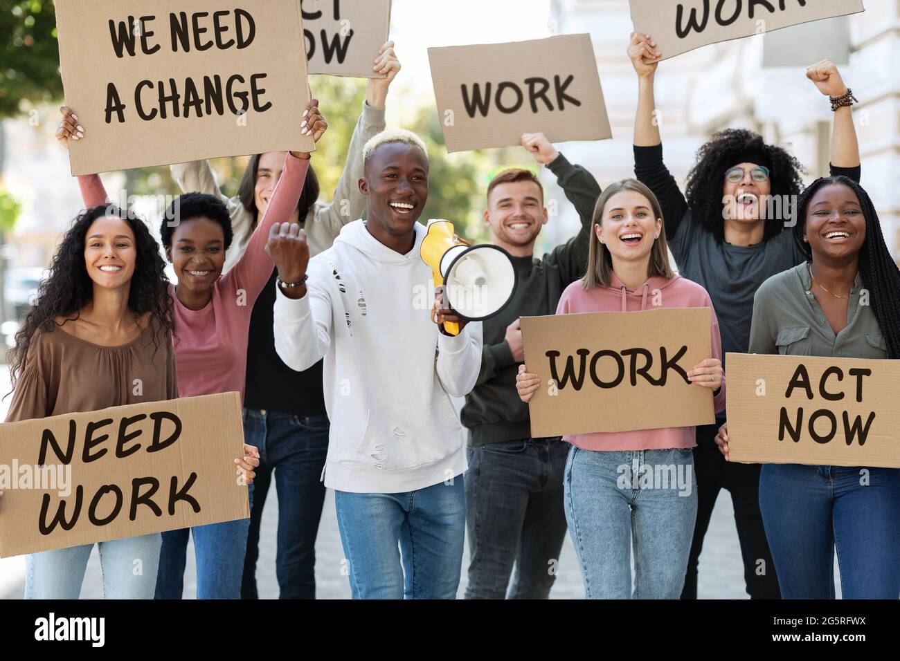 Black man leading multiracial group of people protesting against ...
